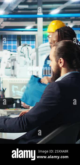 Vertical video Photovoltaics factory manager giving tasks to workers ...