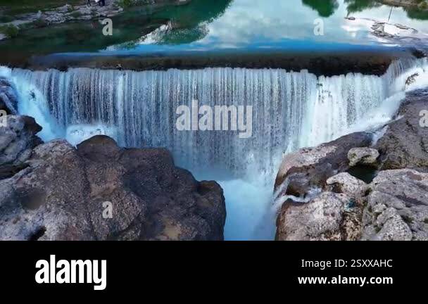 Water falls down a waterfall. Big amount of water falling over a rocky ...