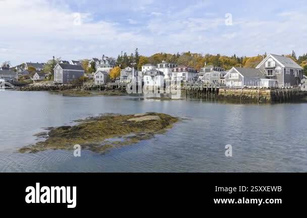Moving clouds over a beautiful fishing town in autumn. Stonington, ME ...