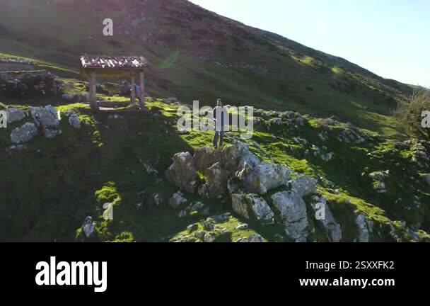 Adventurous hiker contemplating scenic views from limestone rock ...