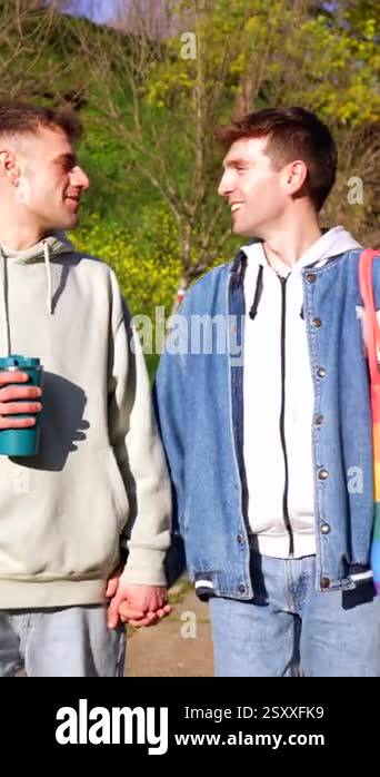 Affectionate Gay Couple Enjoying A Romantic Walk In The Park Holding