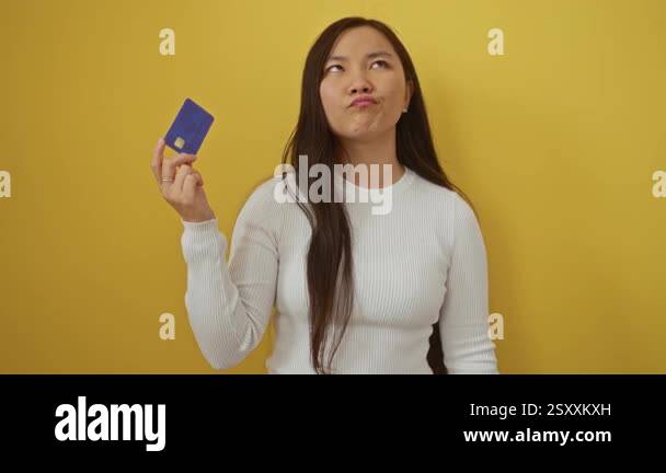 Young chinese woman surprised and happy with an idea, holding credit ...