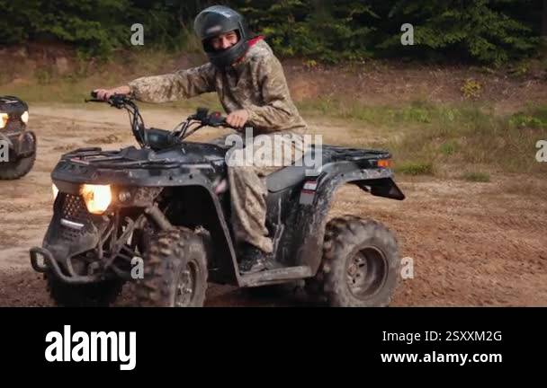 rugged terrain, rough trail, camouflage adventure. Group of ATV ...