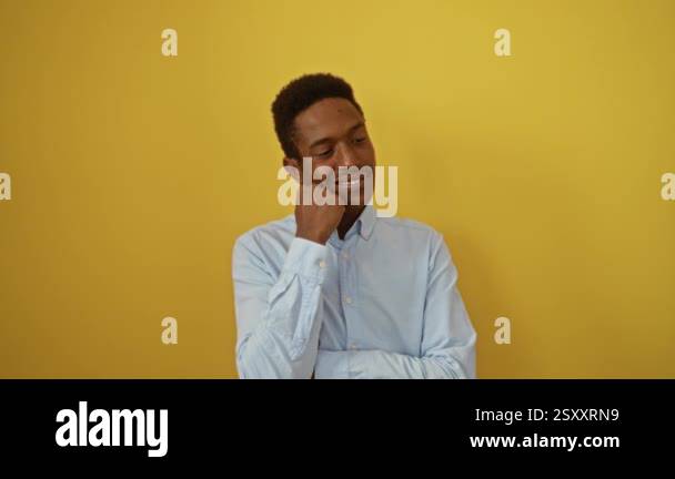 Young african american man wearing a shirt standing in thoughtful pose ...