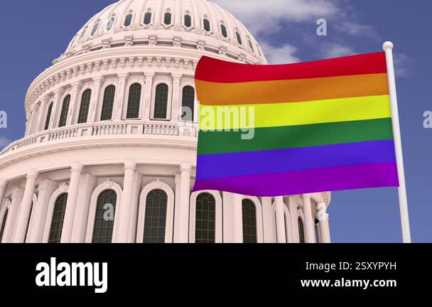 Beautiful flag of LGBT pride waving with the strong wind and behind it the dome of the Capitol ...