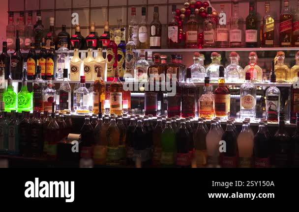 Wide view of a bar showcasing an extensive display of liquor and ...