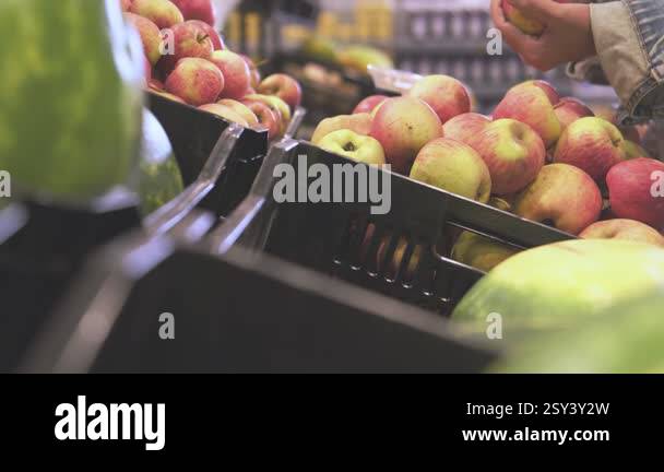 Young Woman Choosing Apple in Grocery Store. Concept of healthy food ...