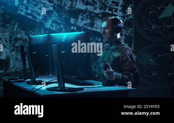 Dramatic scene of a soldier in a dimly lit military control room ...
