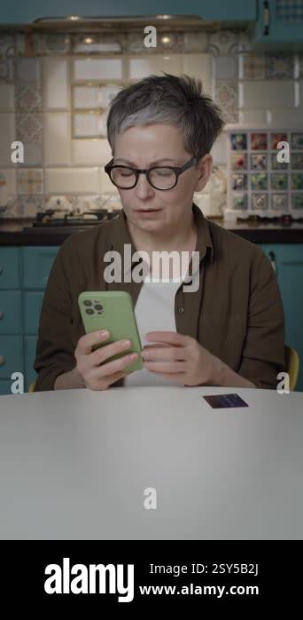 A mature woman looks frustrated while trying to complete an online ... A mature woman looks frustrated while trying to complete an online ...