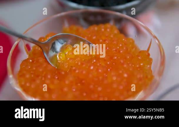 Red Caviar in a spoon background. Close-up of salmon fish roe caviar ...