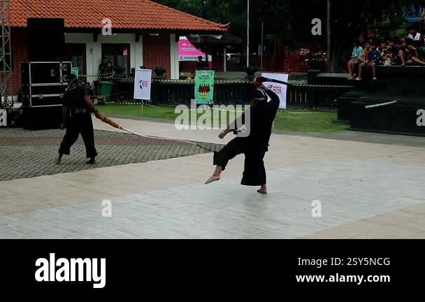Asian Indonesian male dancers play with traditional Javanese whips during a performance of the ...