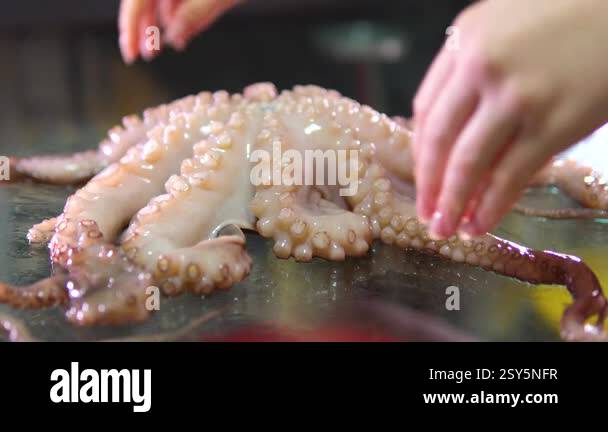 Perfectly cooked octopus placed on a wooden chopping board with hot ...