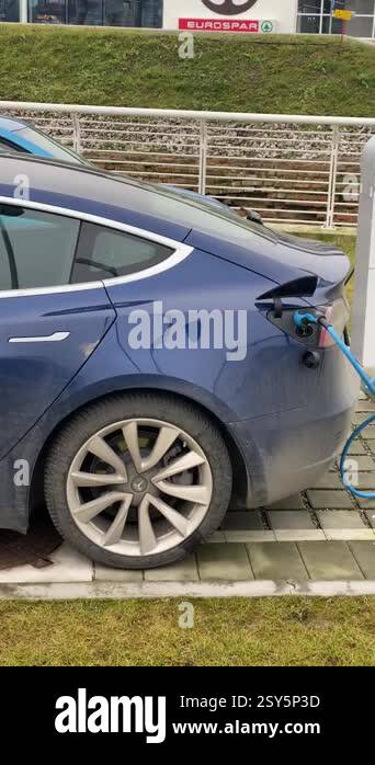 Cremona, Italy February 9th 2025 Blue Tesla model 3 charging at ...