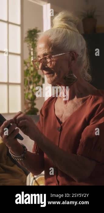 Vertical view of positive senior woman dressed in short sleeve blouse ...