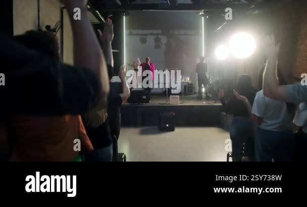 Church service with congregation participating in worship, hands lifted ...
