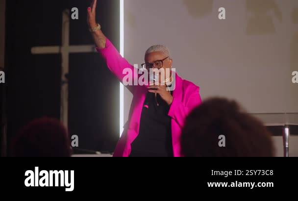 Speaker leading congregation, raising hand in praise, powerful sermon ...