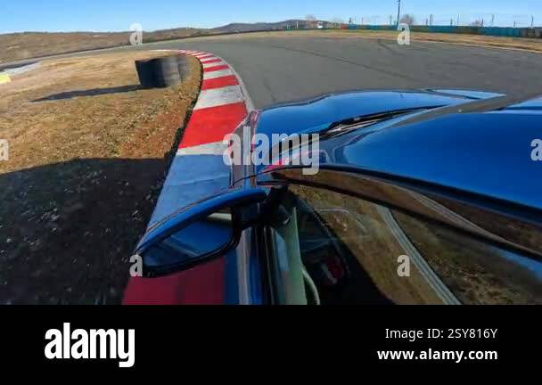 CLOSE UP: Action shot of a brand new luxury car racing on a closed ...