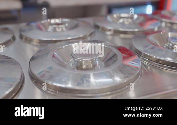 View of multiple chrome ice cream pans arranged on counter top ...