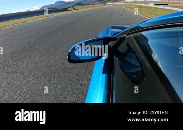 CLOSE UP, LENS FLARE: Sports car races along the scenic closed circuit ...