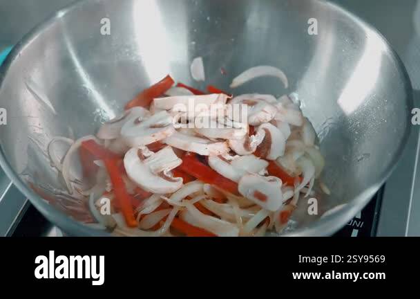 Fresh, colorful vegetables are cooked in a shiny bowl, showcasing their ...