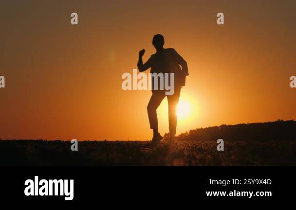 Silhouette of a middle-aged woman performing a humorous dance in a ...