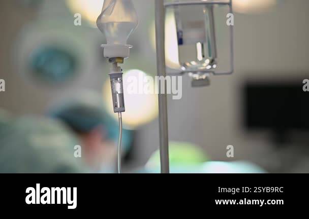 A closeup image of an IV fluid drip in a surgical environment ...