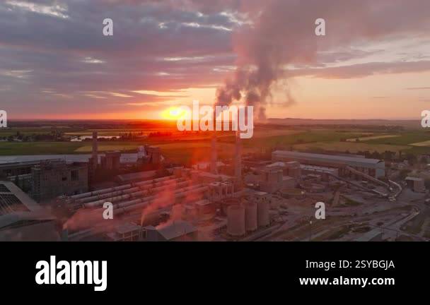 aerial view of two smoking pipes of soviet concrete factory at summer ...