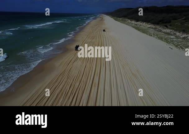 Aerial view of a vast sandy beach in Australia, featuring numerous tire ...