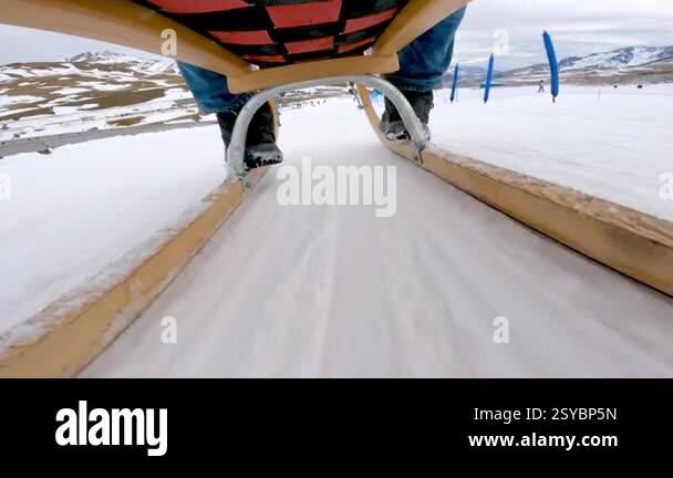 First person view of a tourist wearing blue jeans and black boots ...