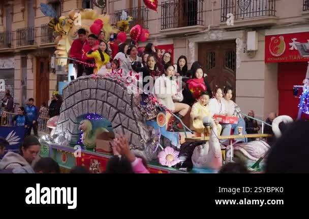 VALENCIA, SPAIN JANUARY 29, 2025: Smiling chinese people waving from a ...