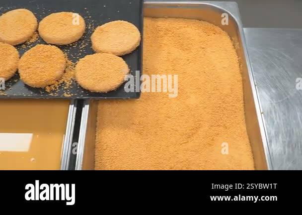 Minced meat formed into cutlets laid out in a tray before baking in a ...