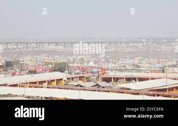 crowded temporary tent shelters with pontoon bridge over ganges river ...