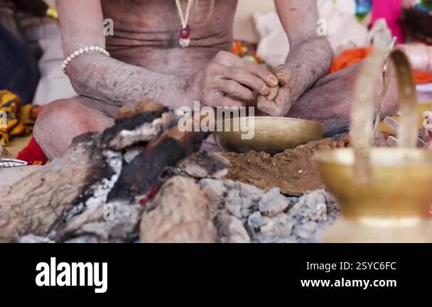 spiritual naga sadhu filling marijuana in pipe during mahakumbh ...