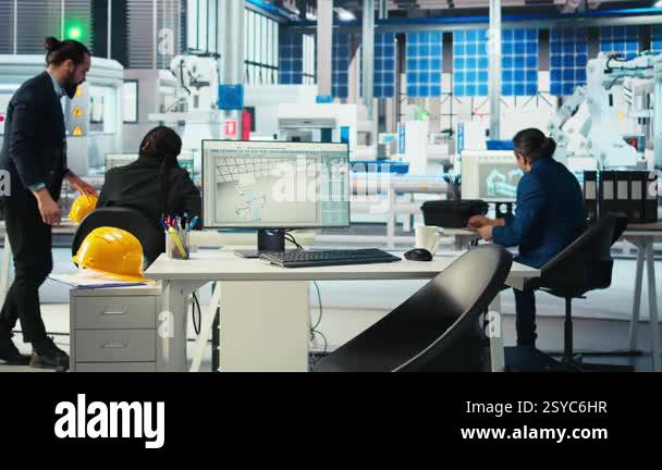 Photovoltaics factory manager working with solar engineering team ...