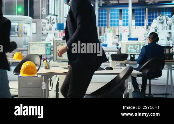 Photovoltaics factory manager working with solar engineering team to ...