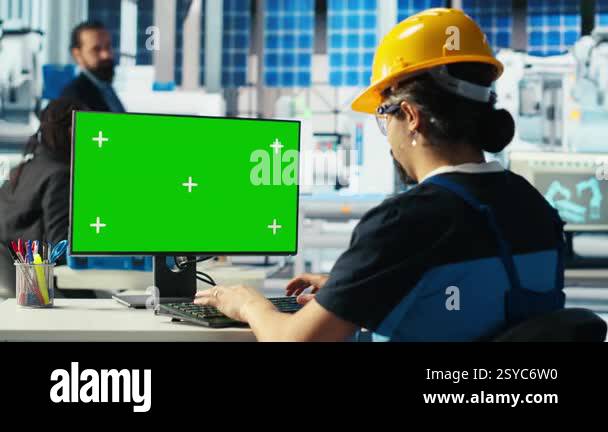 Engineer in solar panels plant using CAD software on mockup PC to optimize layouts ...