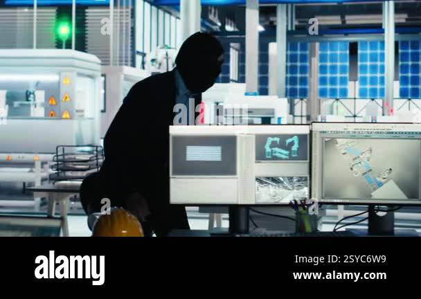 Hacker sneaking into solar panel facility, inserting USB stick into PC ...