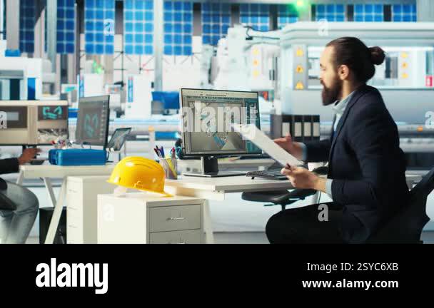 Photovoltaics factory manager looking over paperwork documents ...