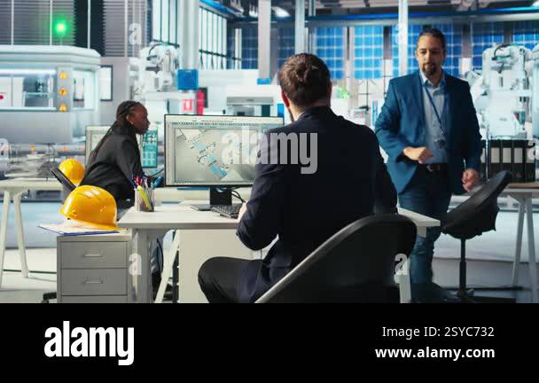 Photovoltaics factory supervisor working with solar engineering expert ...