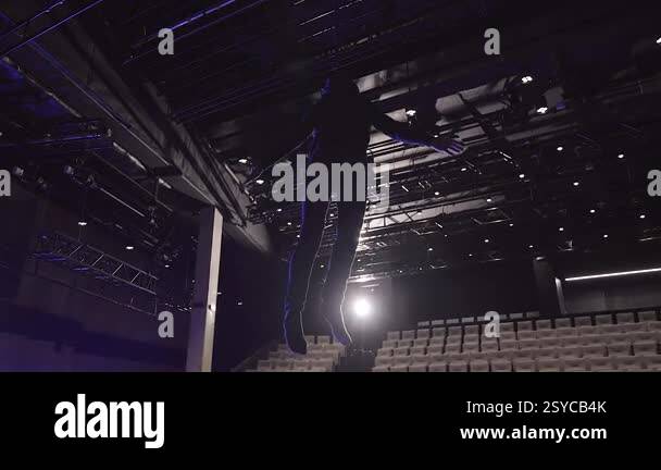 A Man Is Lifted Above the Stage in an Empty Theater Hall Without an ...