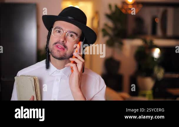 Handsome traditional jewish man with book adn phone Stock Video Footage ...