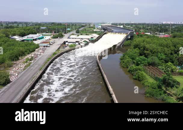 An elevated canal above the road is draining water into the sea Stock ...