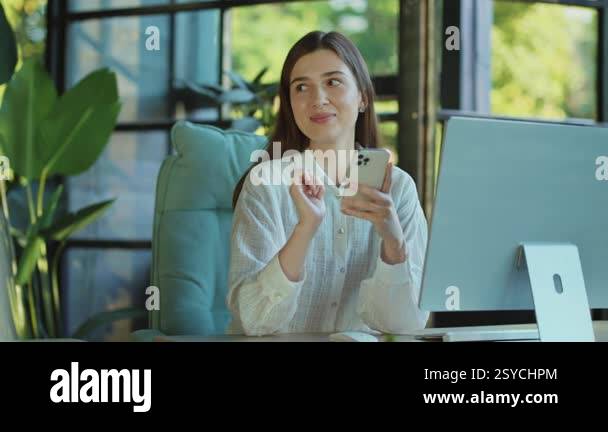 Young Caucasian attractive woman in love holding smartphone, reading ...
