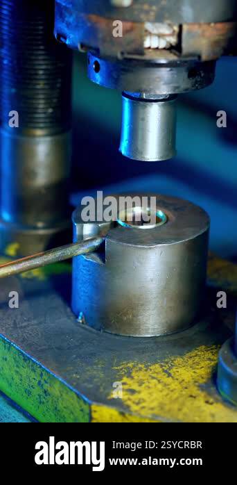 Industrial worker on metal press machine. Worker operating metal press ...