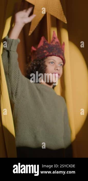 Slow motion shot of biracial child actor standing on stage with ...
