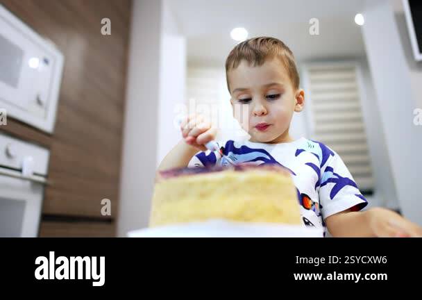 Adorable toddler boy chewing his food carefully. Low angle view at the ...