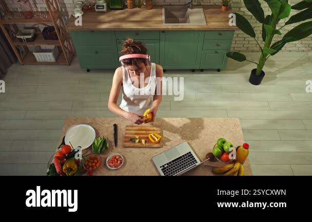 Healthy eating concept. Young woman at the table in the kitchen ...