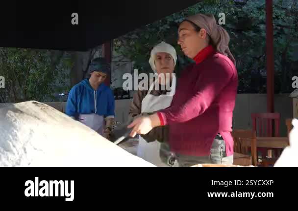 Traditional Turkish bread baking in a tandoor (clay oven). Ramadan ...