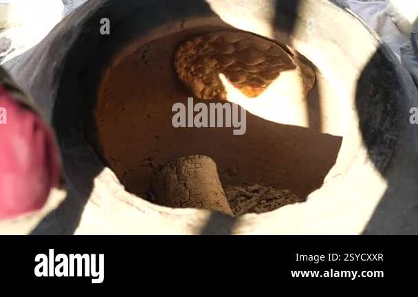 Traditional Turkish bread baking in a tandoor (clay oven). Ramadan ...