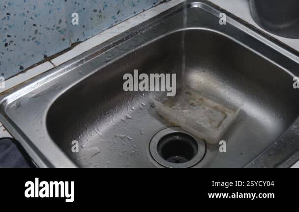 Pouring water into a plastic container and then transferring it to ...